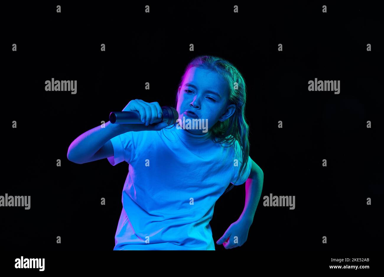 Portrait of little beautiful girl, child in white T-shirt posing ...