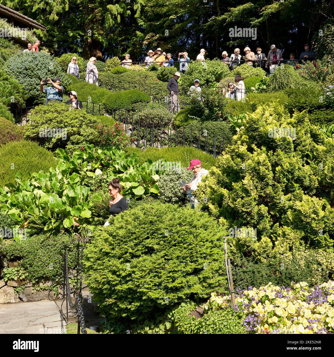 People walking on the path down to the sunken garden at Butchart ...