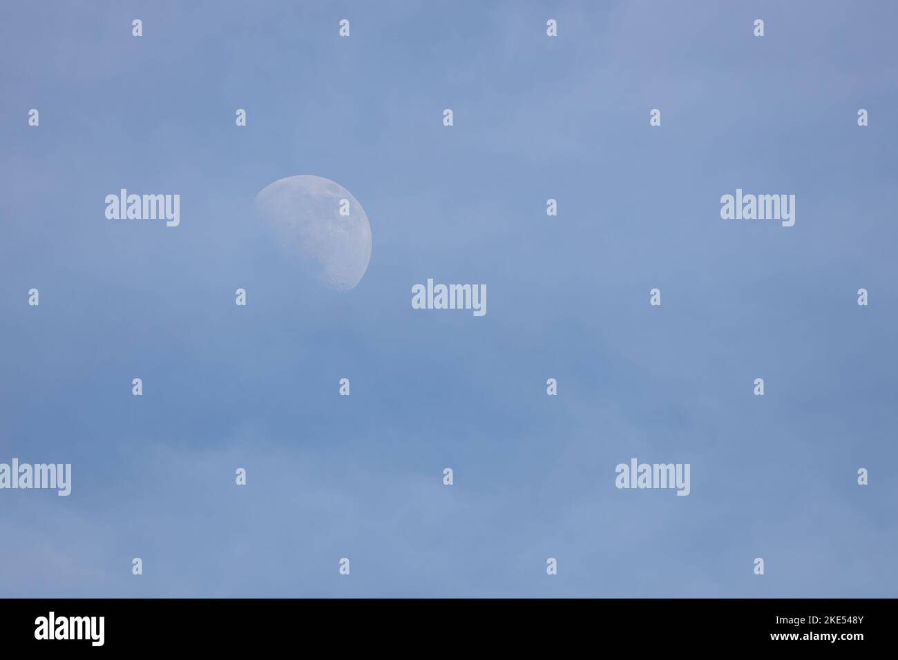 The Moon in a blue cloudy sky, perfect for wallpapers and backgrounds ...
