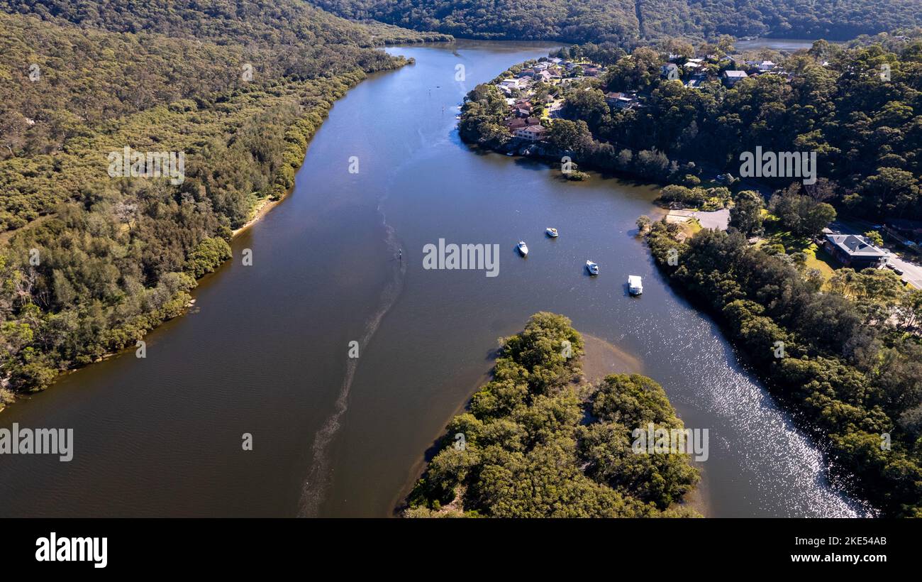 Aerial view of Woronora River surrounded by lush greenery in Sutherland ...