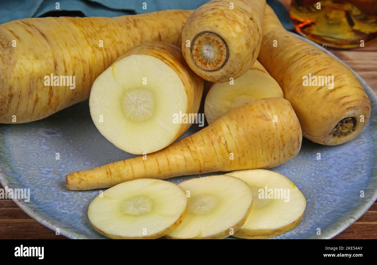 Closeup of group many raw isolated sliced parsnip root vegetables on ...