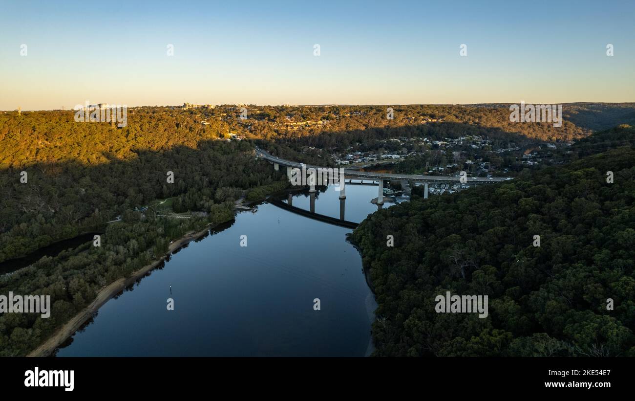 Aerial view of Woronora River surrounded by lush greenery and Woronora ...