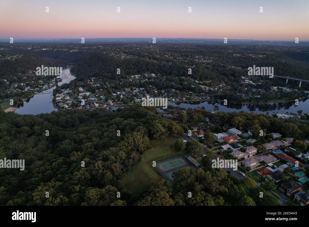 Aerial view of Woronora River surrounded by lush greenery and Woronora ...