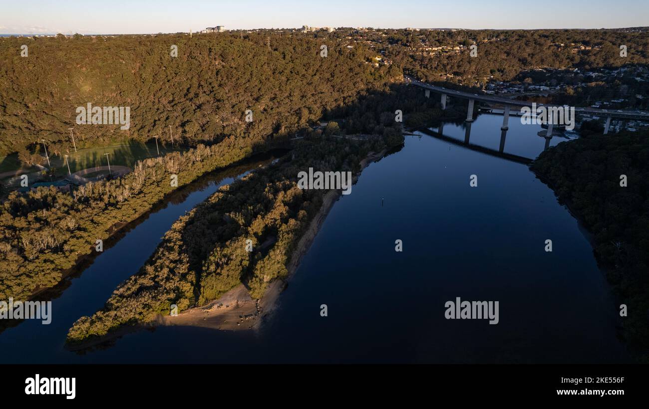 Aerial view of Woronora River surrounded by lush greenery and Woronora ...