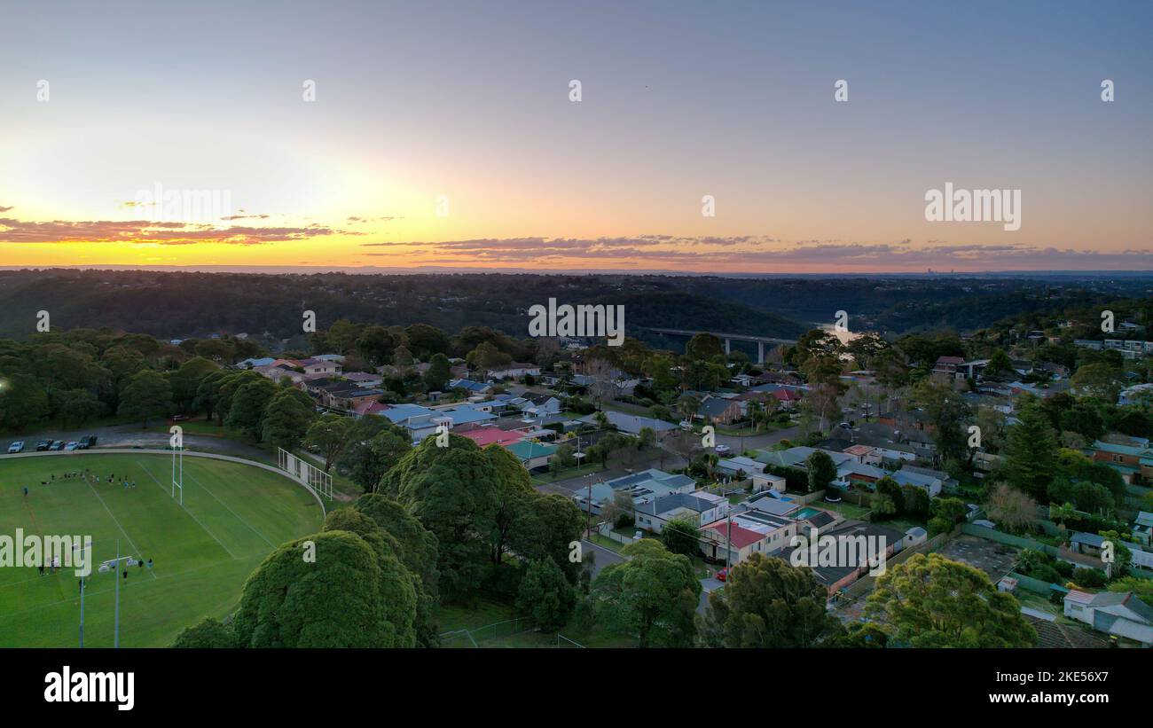 An aerial view of sporting ground, Sutherland Oval and suburb at dusk ...