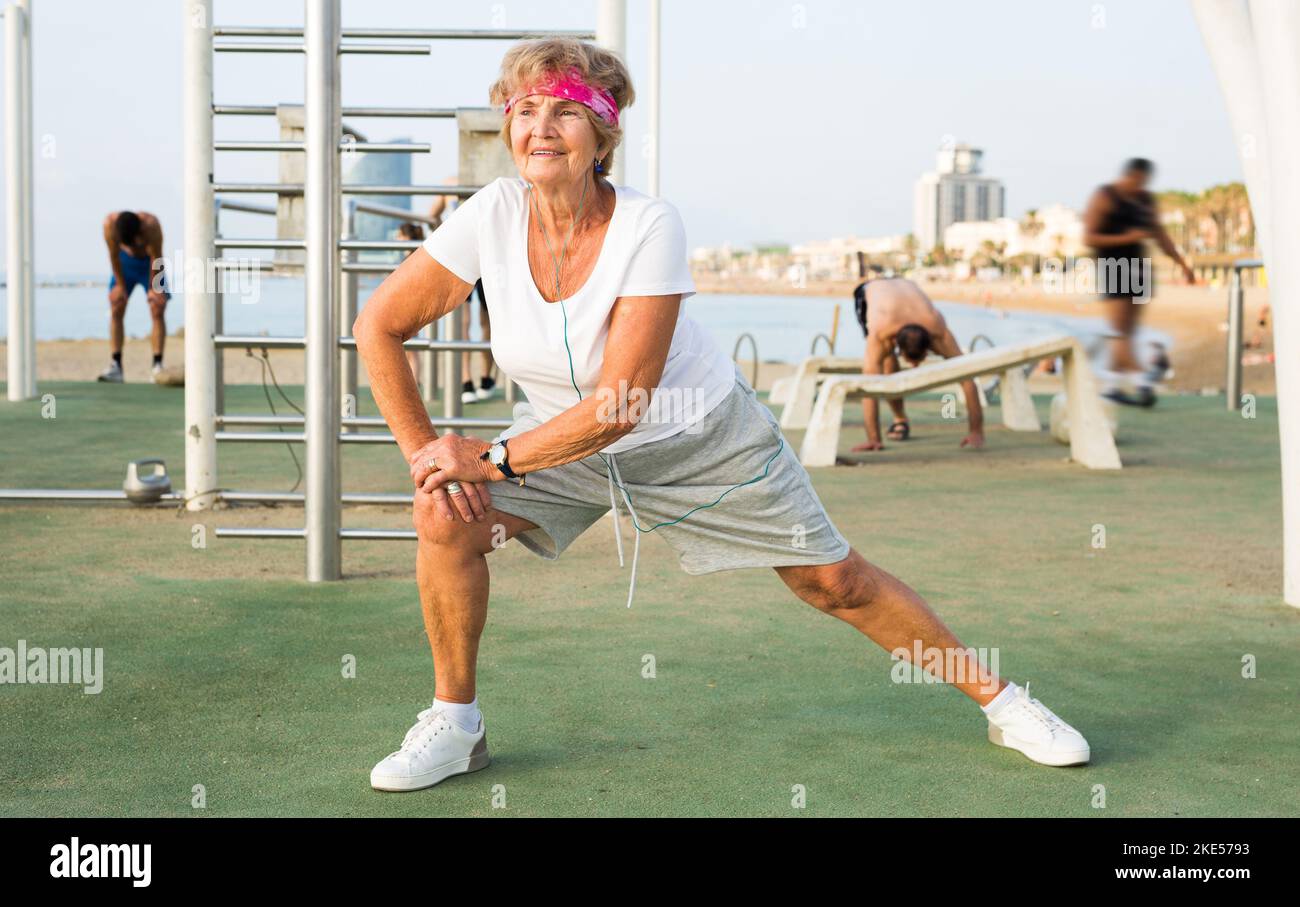 Old woman doing fitness exercises outdoors Stock Photo - Alamy