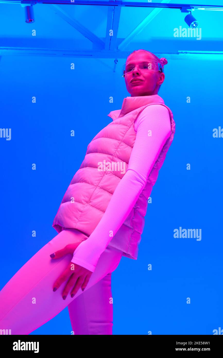 Woman in futuristic costume. Female in modern VR glasses interacting ...