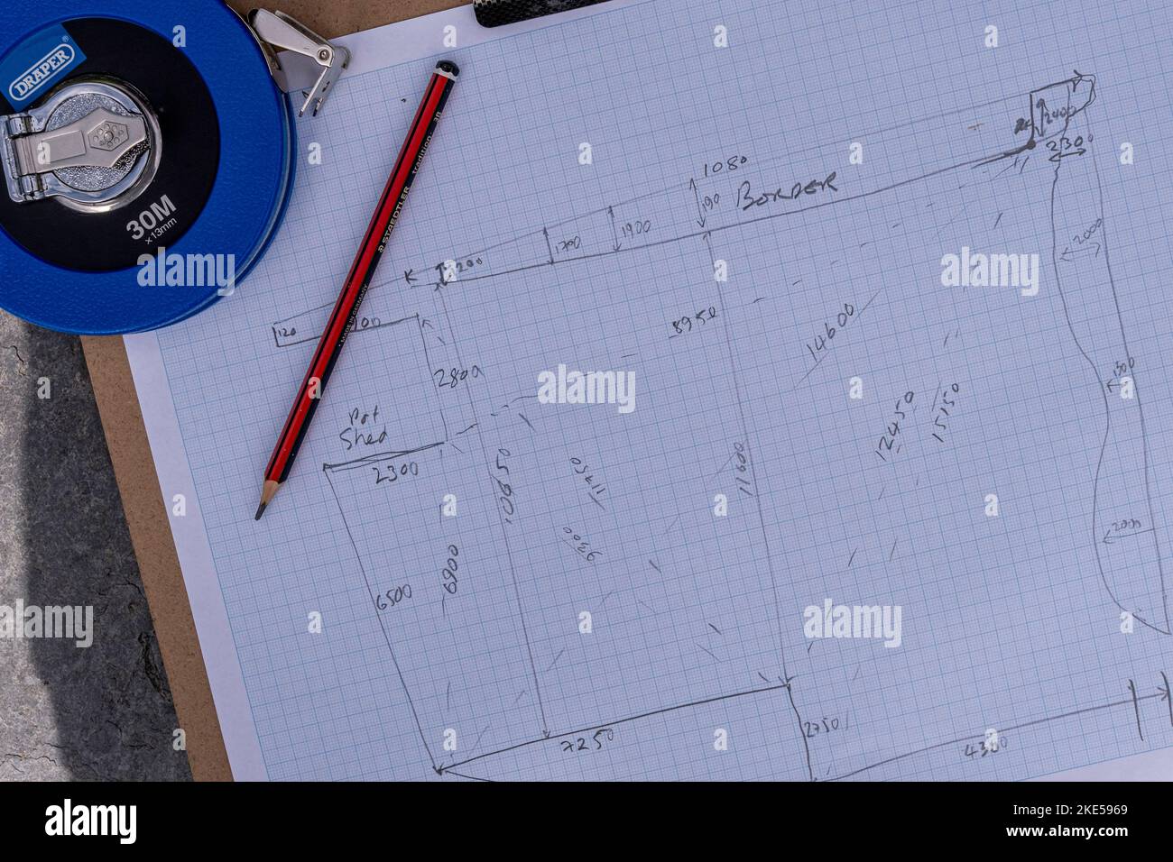 making a plan of a garden using tape measure, graph paper and a pencil ...