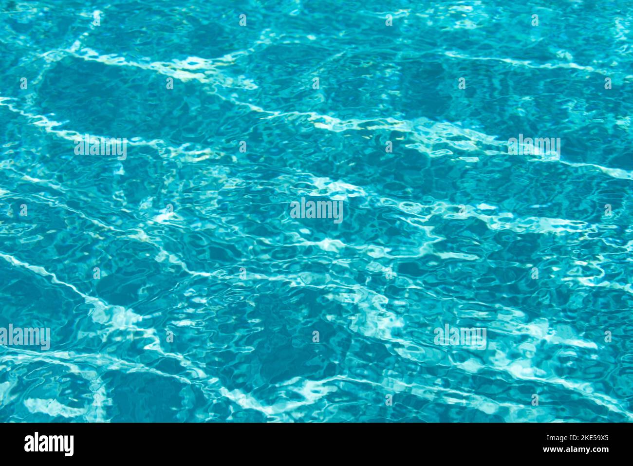Background of blue water in swimming pool with sun reflection, ripple ...