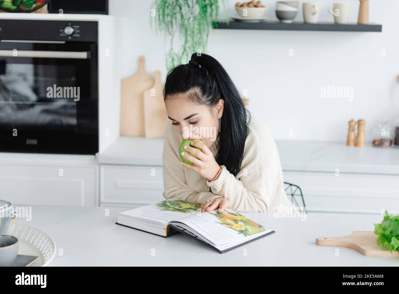 Healthy Eating. A young woman eats a lot of greens. Self-care. Woman ...