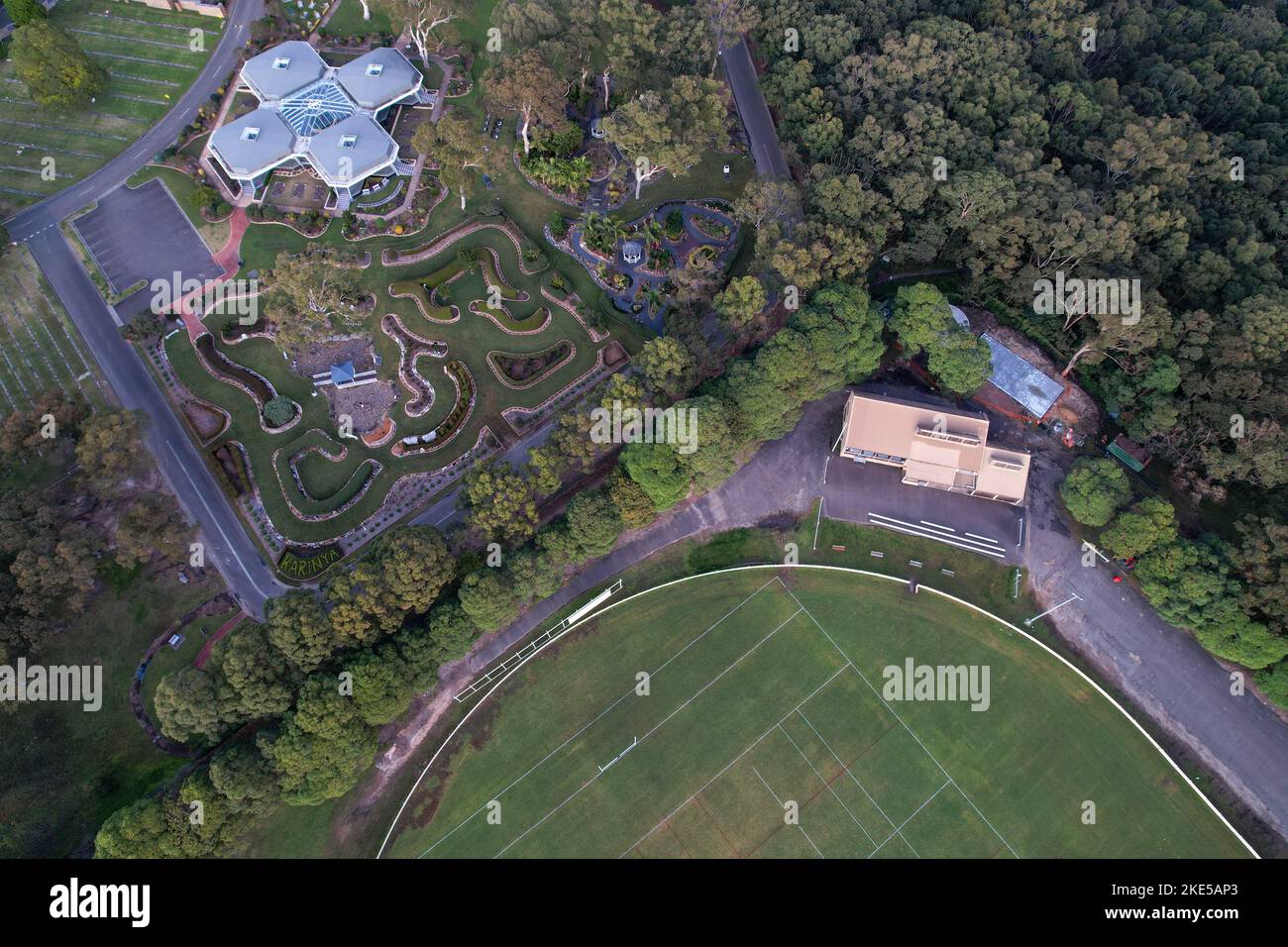 An aerial view of sporting ground, Sutherland Oval and suburb at dusk ...