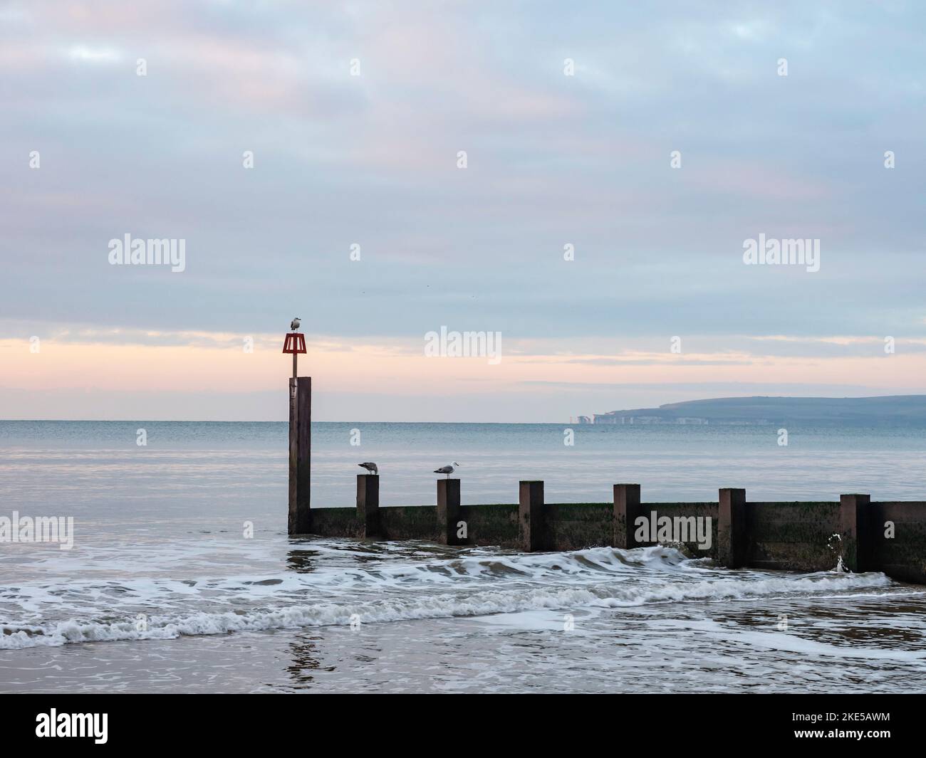 Dawn on the beach looking towards Old Harry Rocks and Purbeck Coast ...