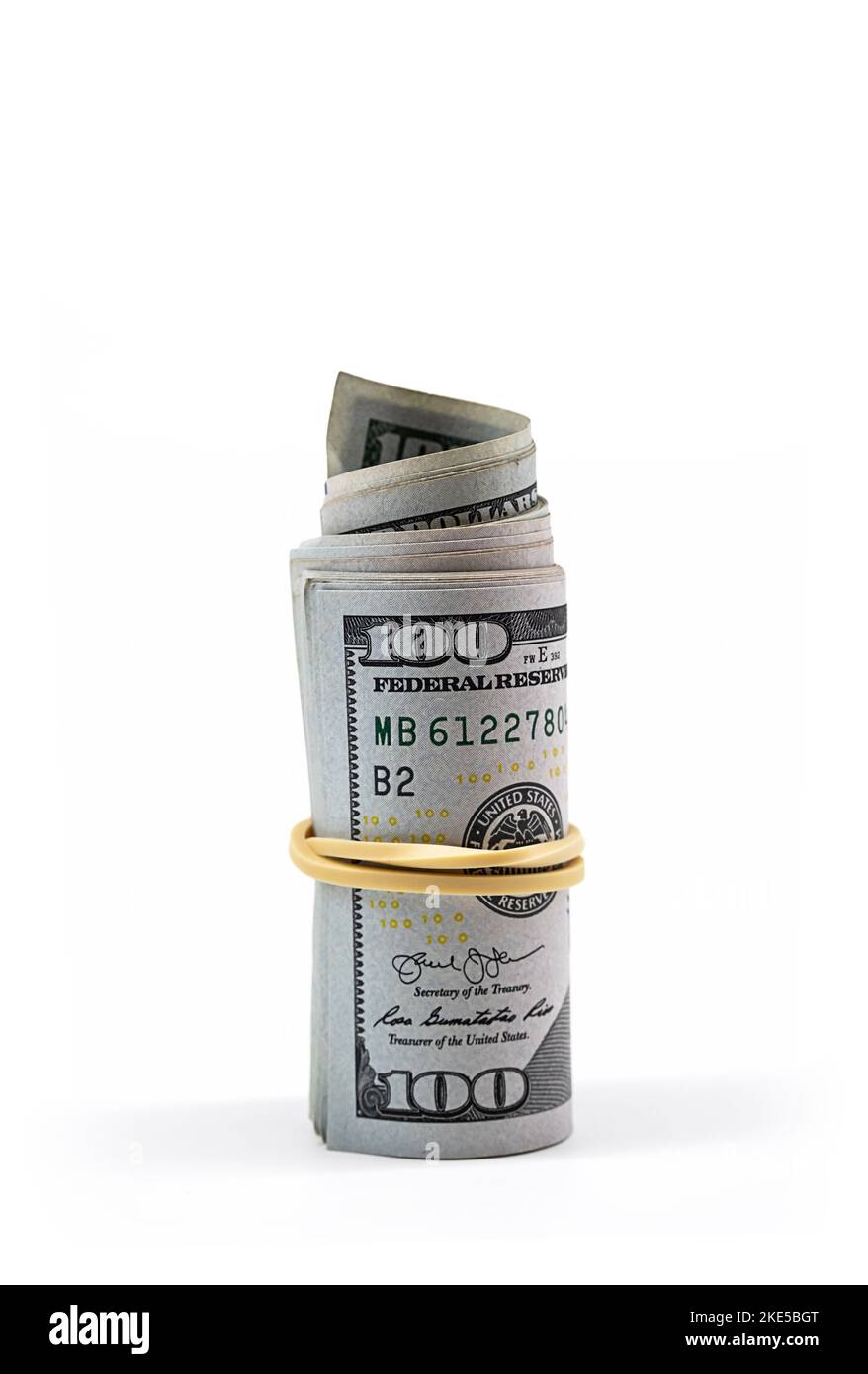 Rolled up one hundred dollar bills on white. Roll of U.S. paper ...