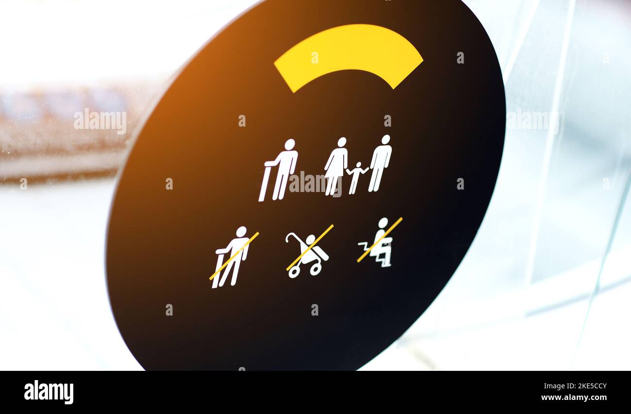 warning signs on an escalator at the shopping mall in Spain, safety ...