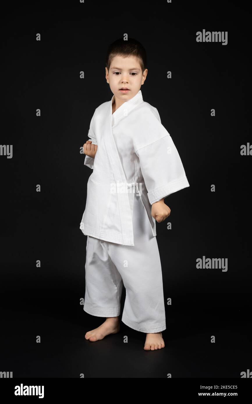 A little boy practices martial arts, karate classes in kimono on a ...