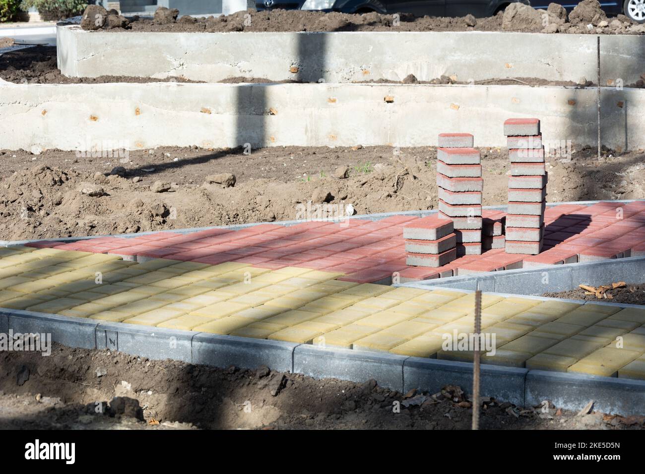 Colored paving slabs. Construction of footpaths from paving slabs Stock ...