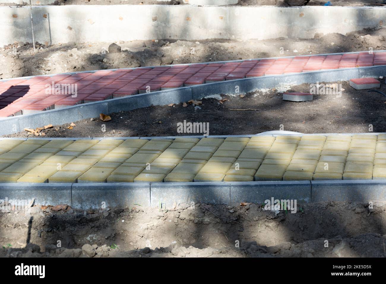 Colored paving slabs. Construction of footpaths from paving slabs Stock ...