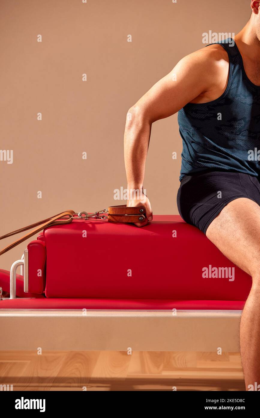 Pilates reformer workout exercises man at gym indoor Stock Photo - Alamy