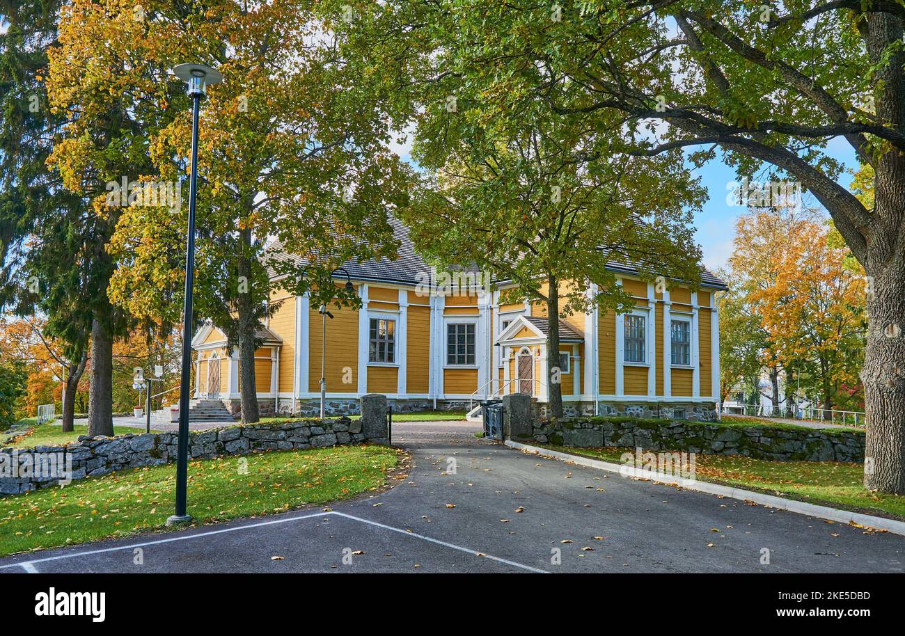An exterior view of a church in Finland with yellow walls during autumn ...