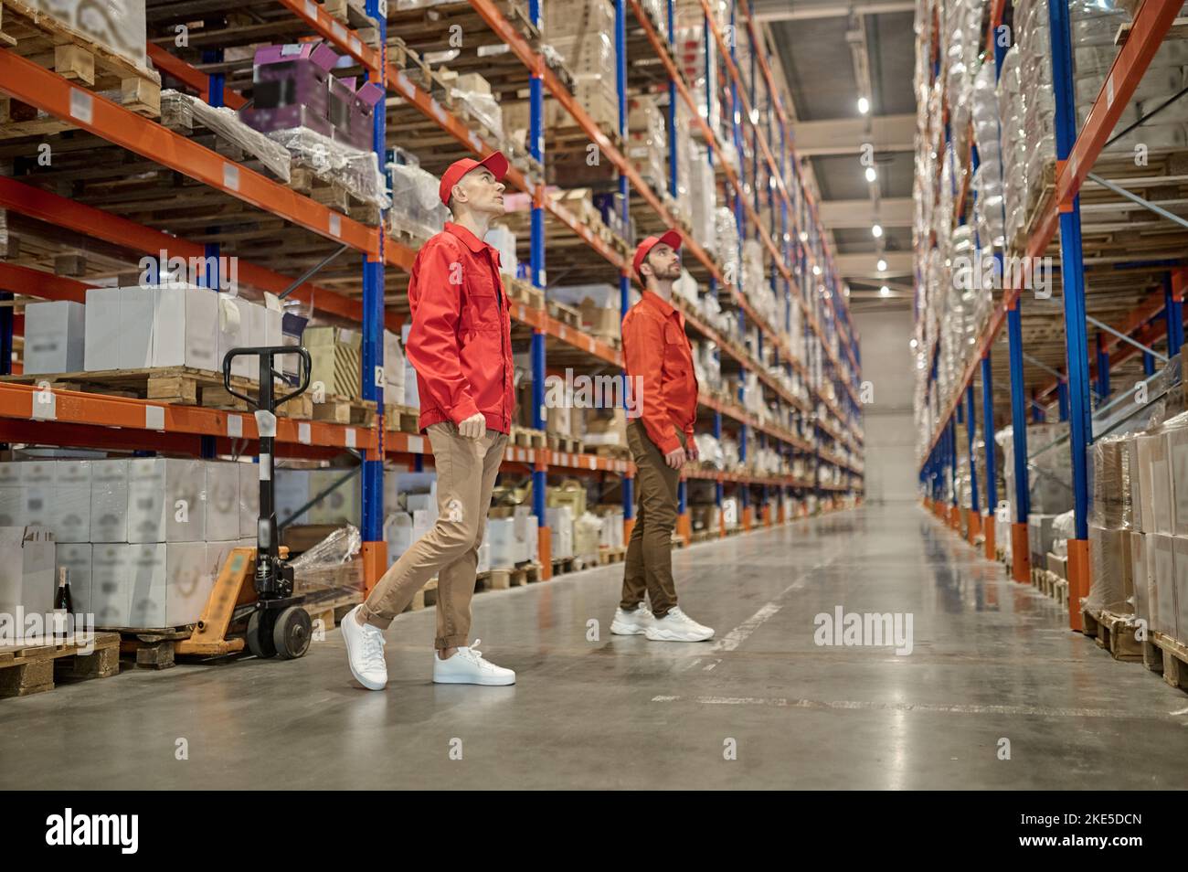 Experienced warehouse staff conducting a racking system inspection ...