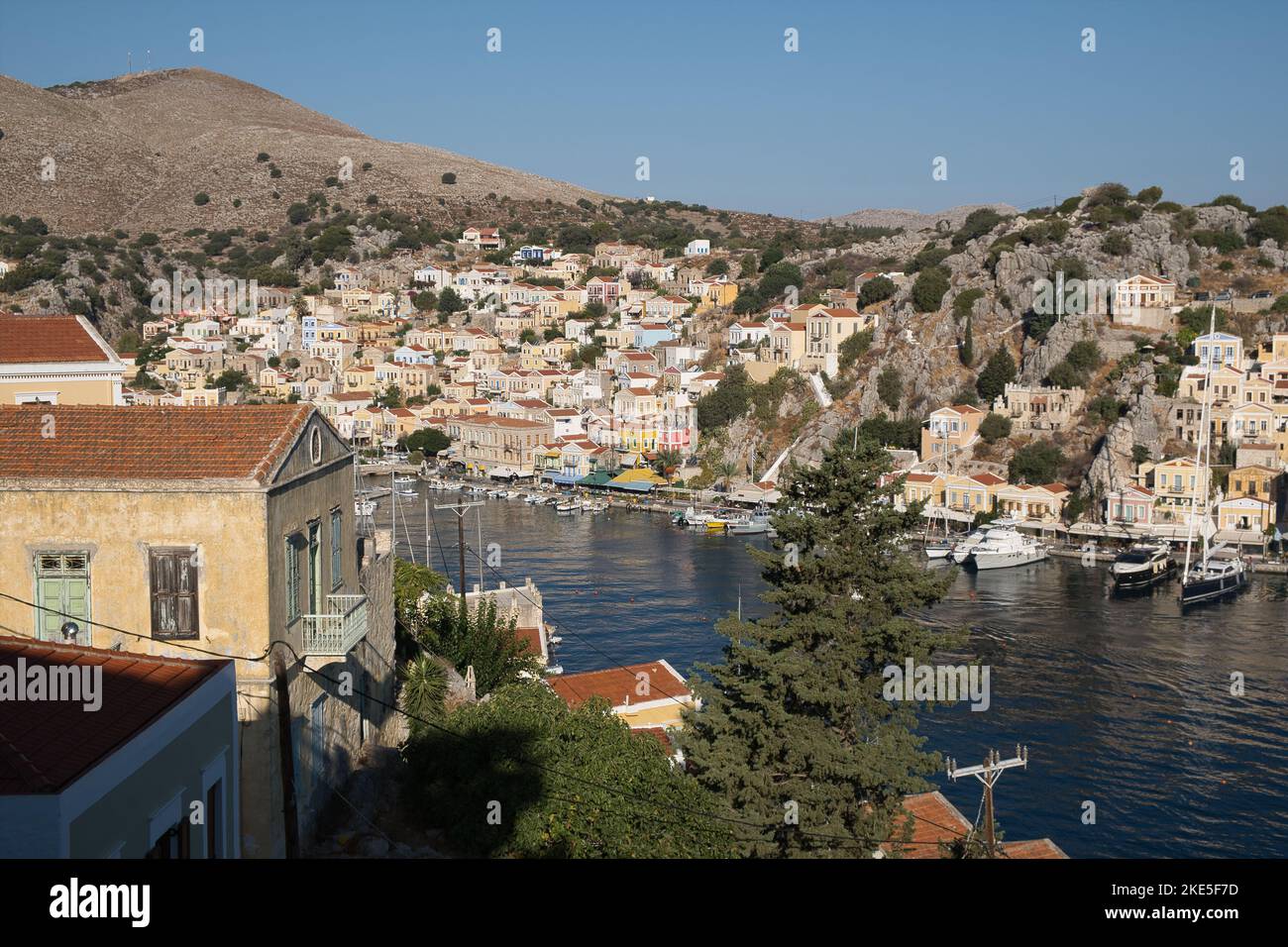 A beautiful view of the Symi Harbor on Symi Island, Greece with boats ...