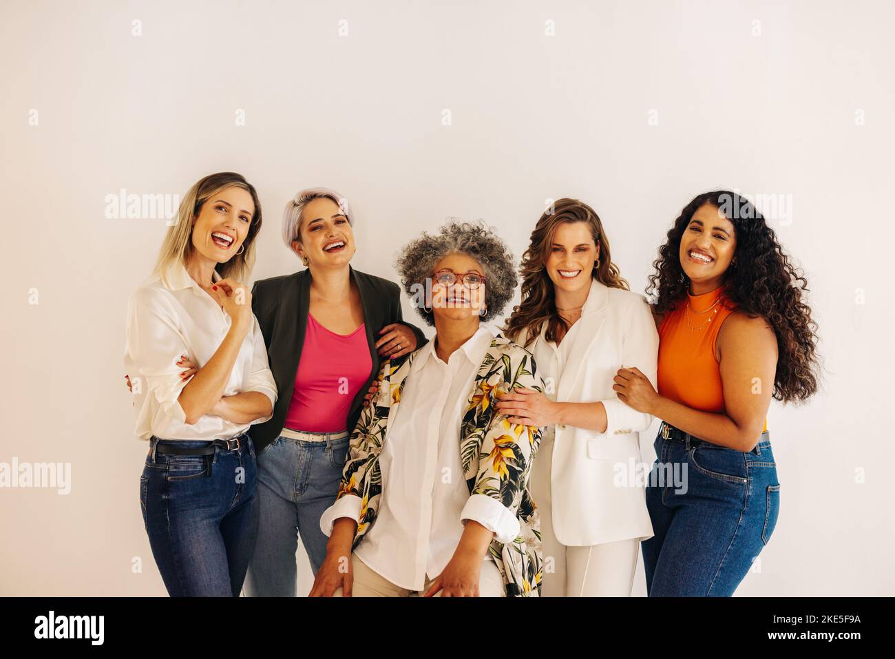 Diverse female entrepreneurs smiling at the camera while standing ...