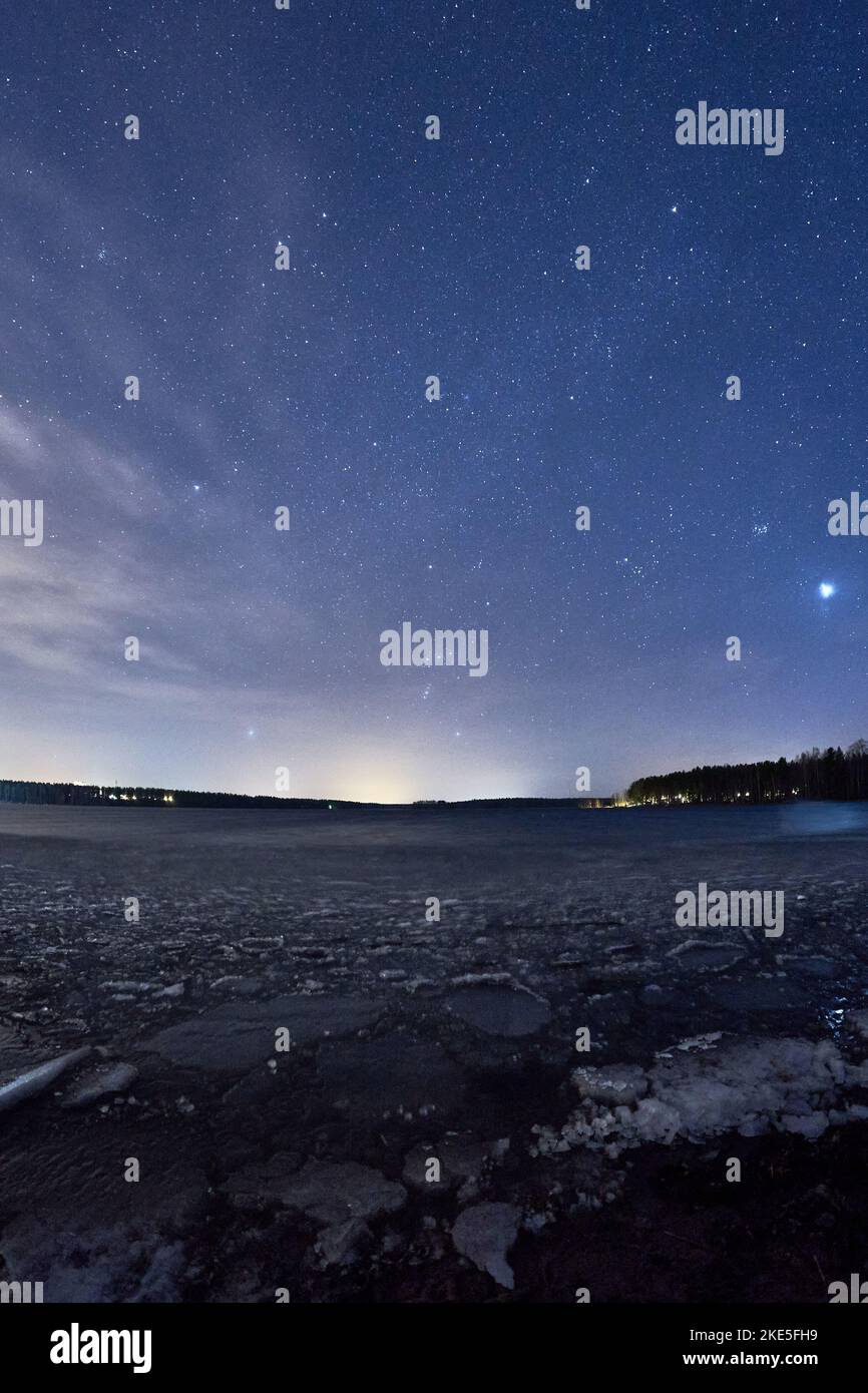 A beautiful scenery of a starry sky with clouds and shades of blue in a ...