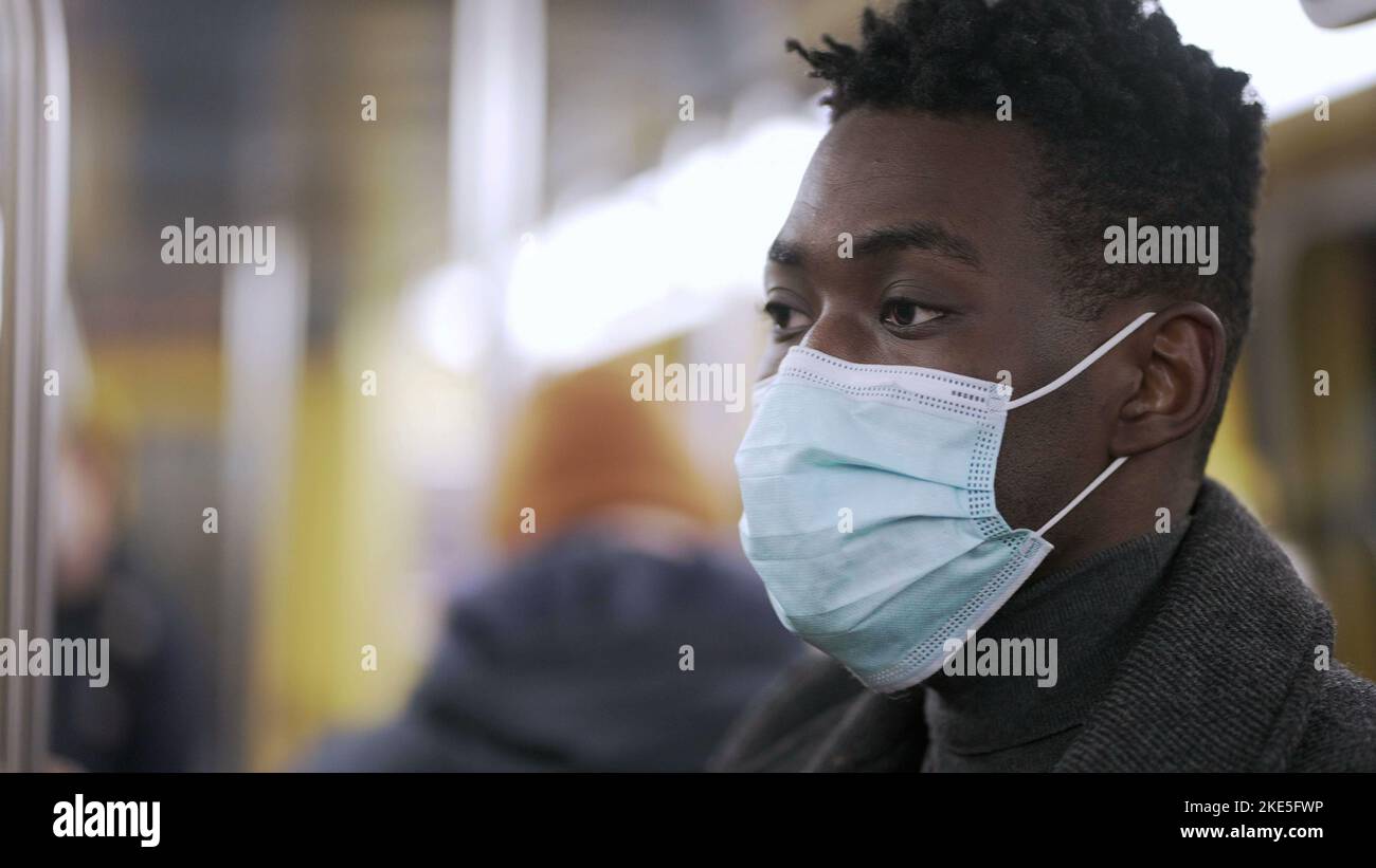Black man standing at metro subway wearing covid-19 face mask during ...