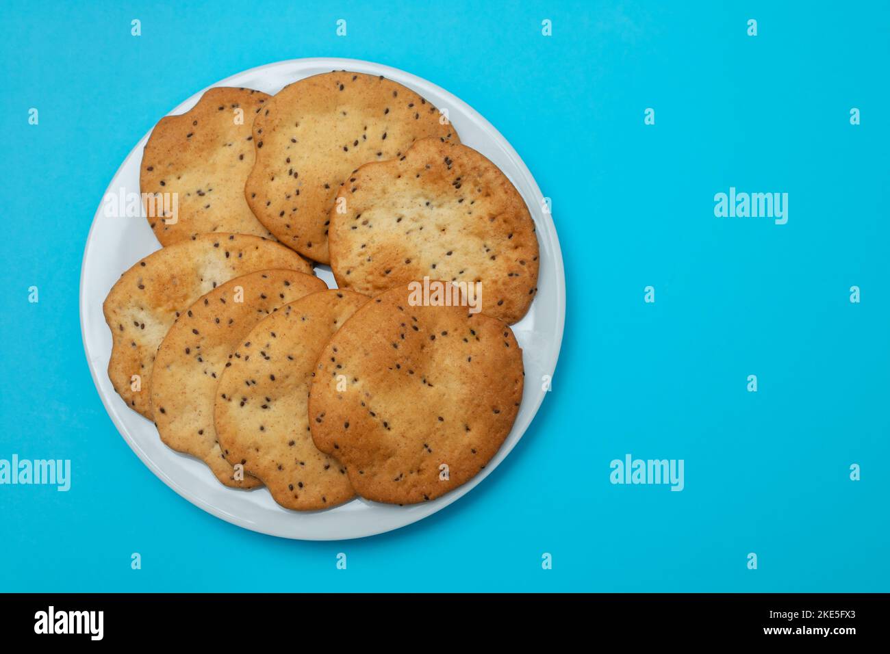 butter cookies isolated on light brown plate on blue Stock Photo - Alamy