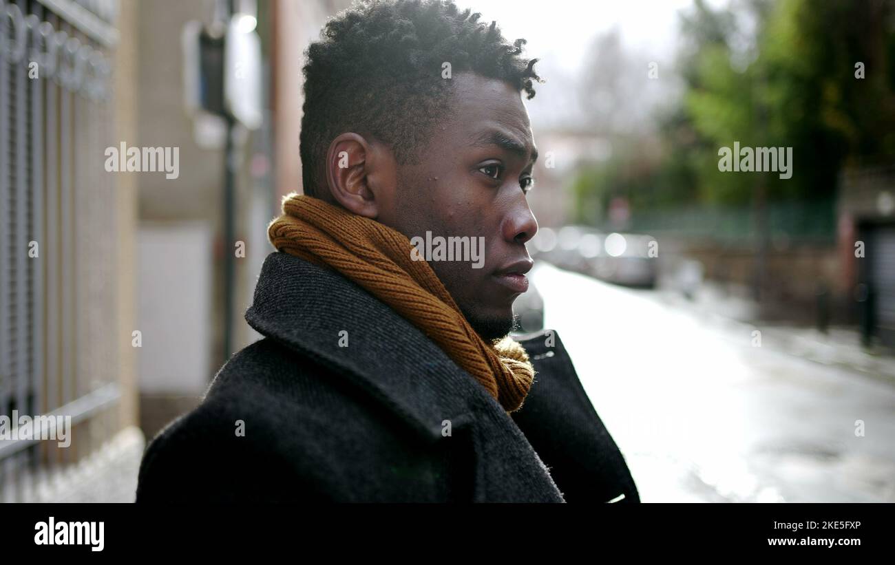 Black man standing outside in city during winter season Stock Photo - Alamy