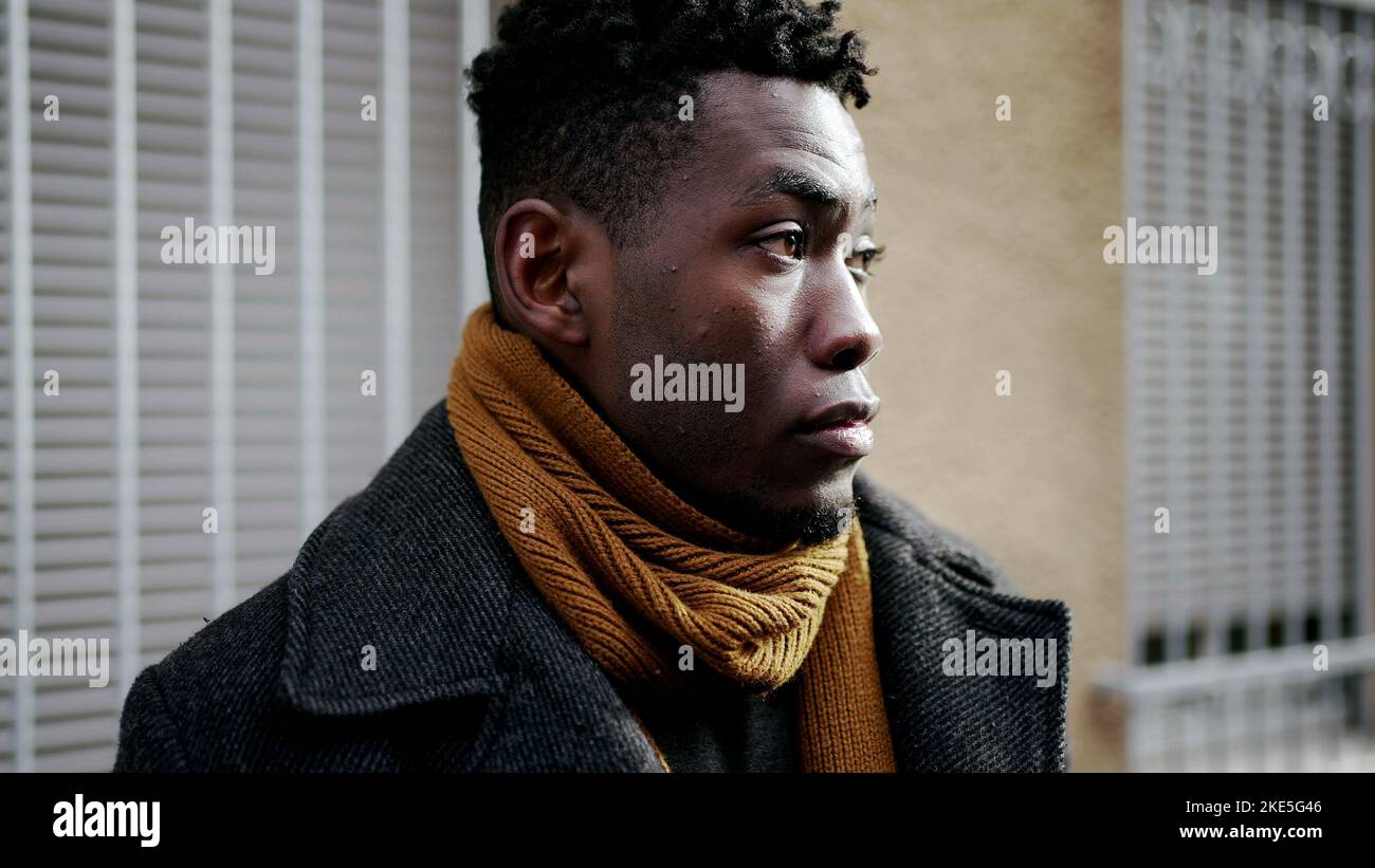 Black man standing outside in city during winter season Stock Photo - Alamy