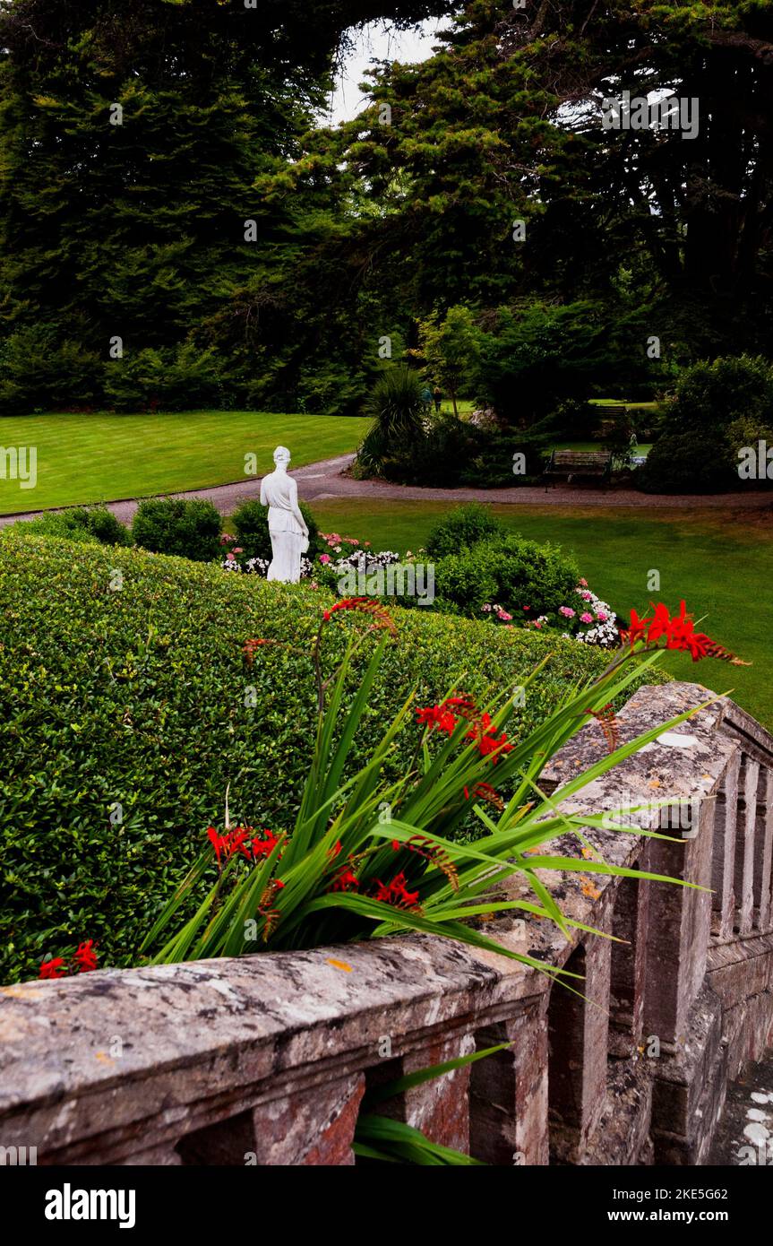 Elegant stone balustrade draped in Crocosmia Lucifer and formal gardens ...