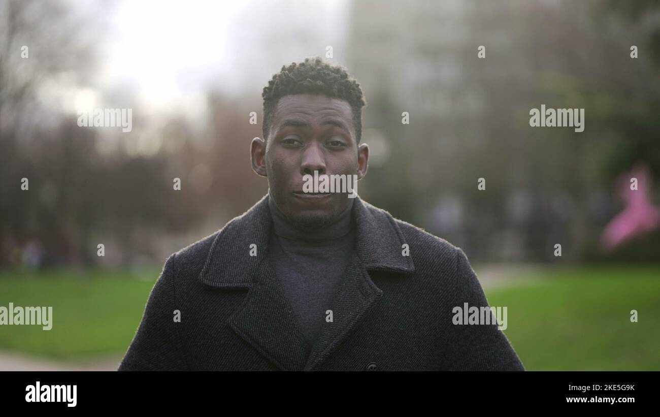 Black man standing outside in the cold wearing winter coat freezing ...