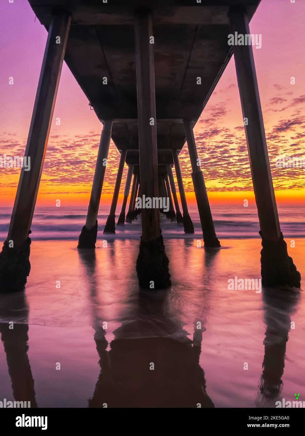 A vertical shot of the colorful sunset under the pier Stock Photo - Alamy