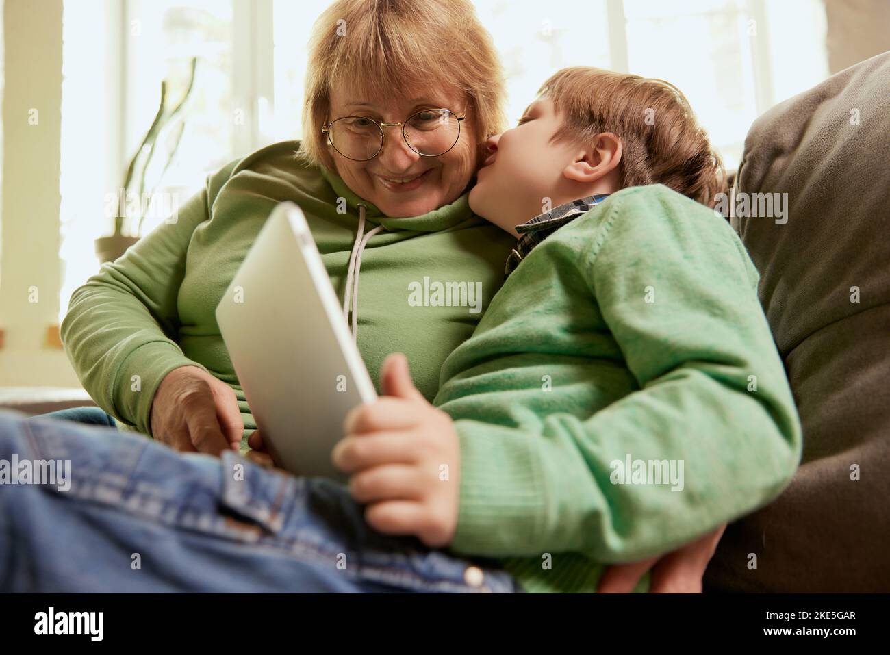 Happy grandmother and grandson spending time together at home. Concept ...