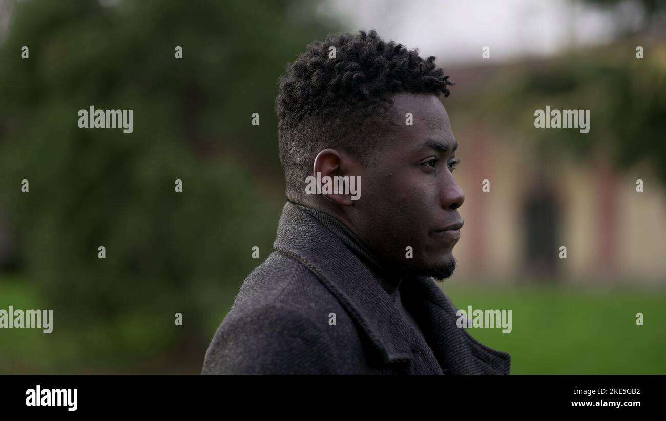 Black man standing outside in the cold wearing winter coat freezing ...