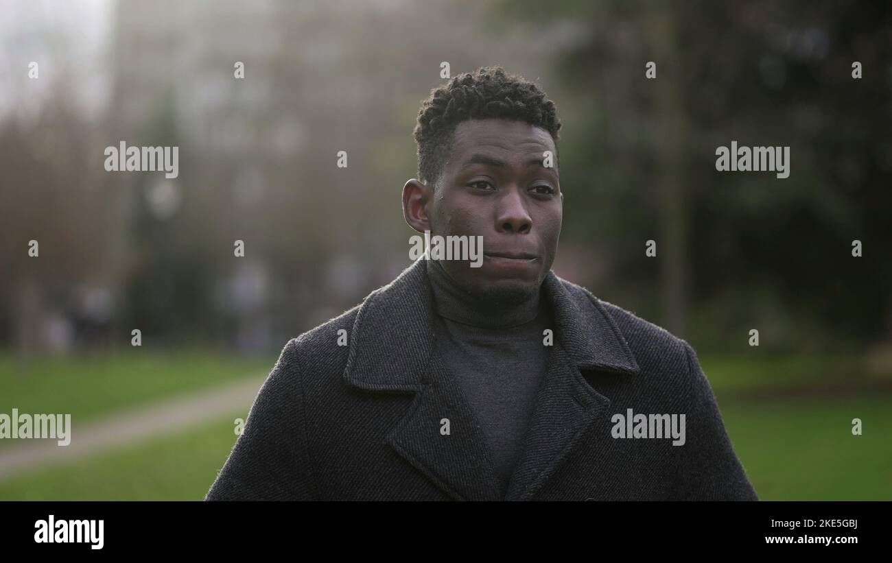 Black man standing outside in the cold wearing winter coat freezing ...