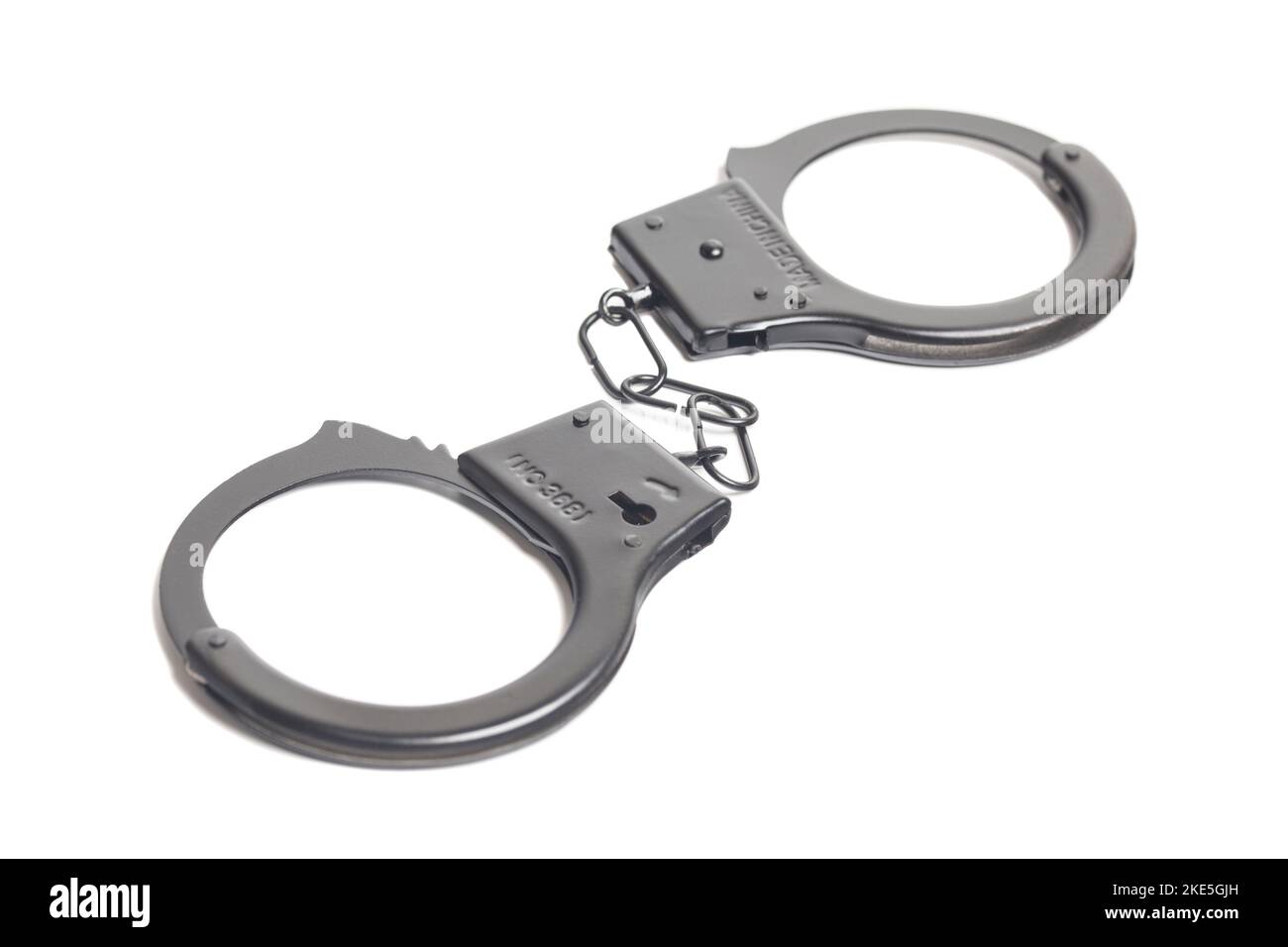 Handcuffs isolated on white background Stock Photo - Alamy