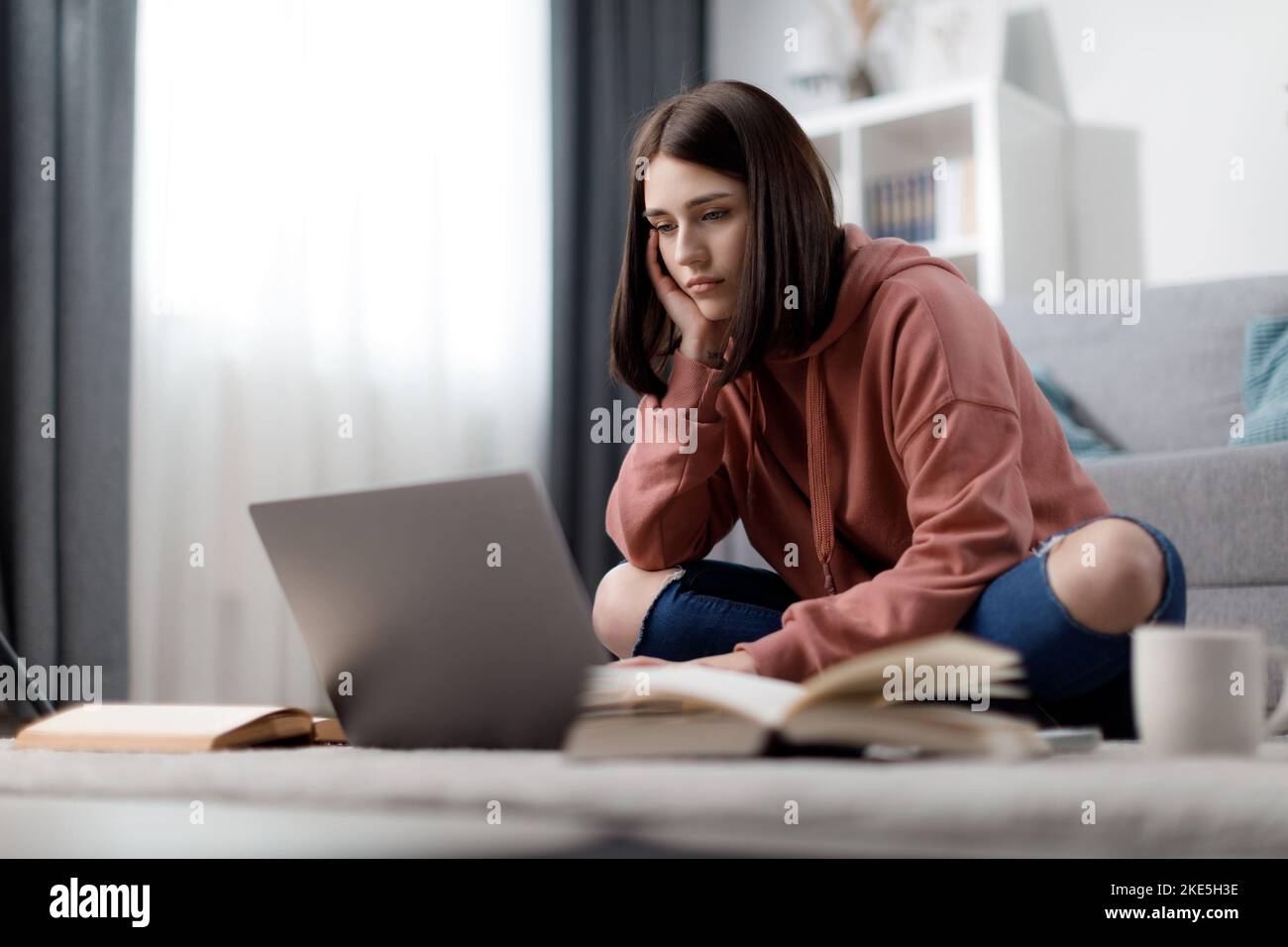 Woman using laptop for studying Stock Photo - Alamy