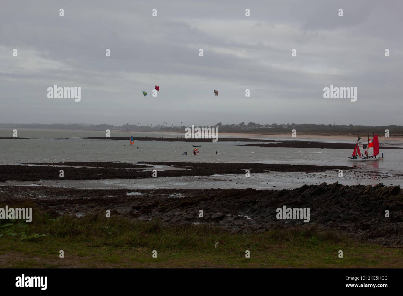 Coastal scene with boats and kite surfing, very windy, bad weather. The ...
