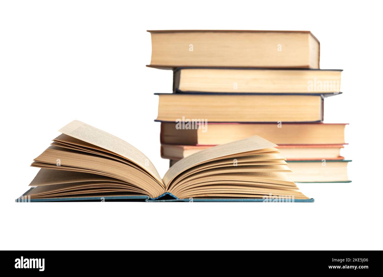 An open hardcover book and a stack of books on a white background ...