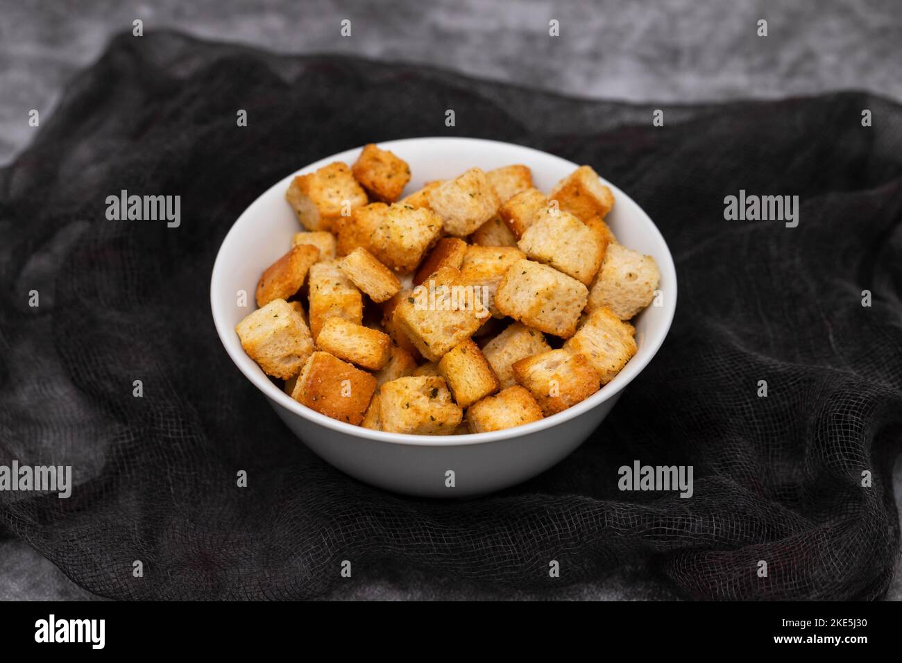 Crispy dry cubes of white bread in white bowl Stock Photo - Alamy