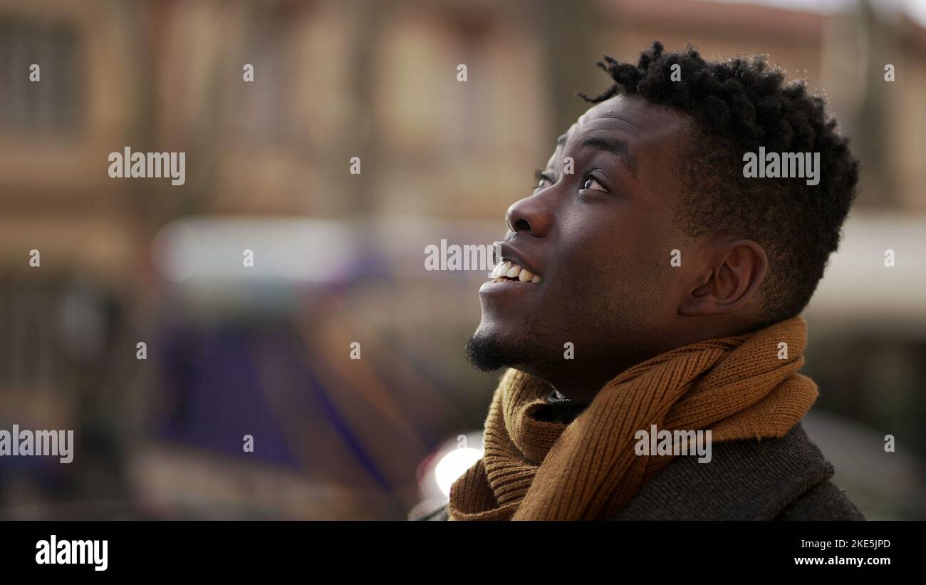 Black man looking at sky smiling with HOPE and FAITH Stock Photo - Alamy