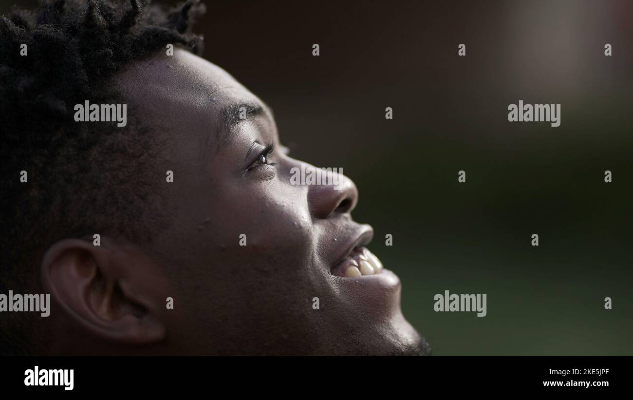 Black man opening eyes to sky with HOPE smiling feeling grateful and ...