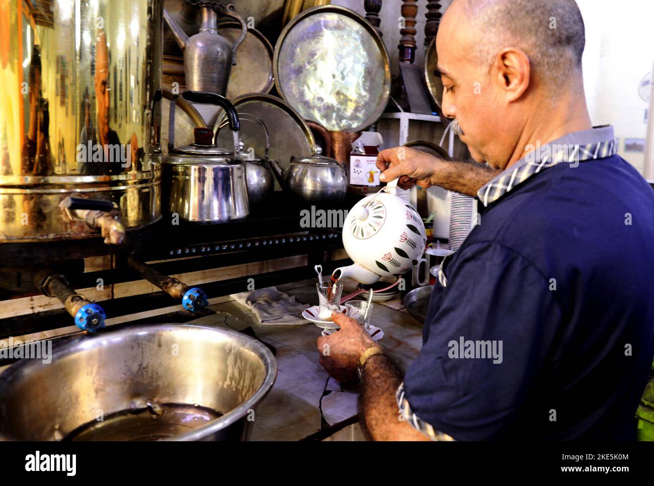 Baghdad, Iraq. 10th Nov, 2022. A man serves tea to customers at the ...