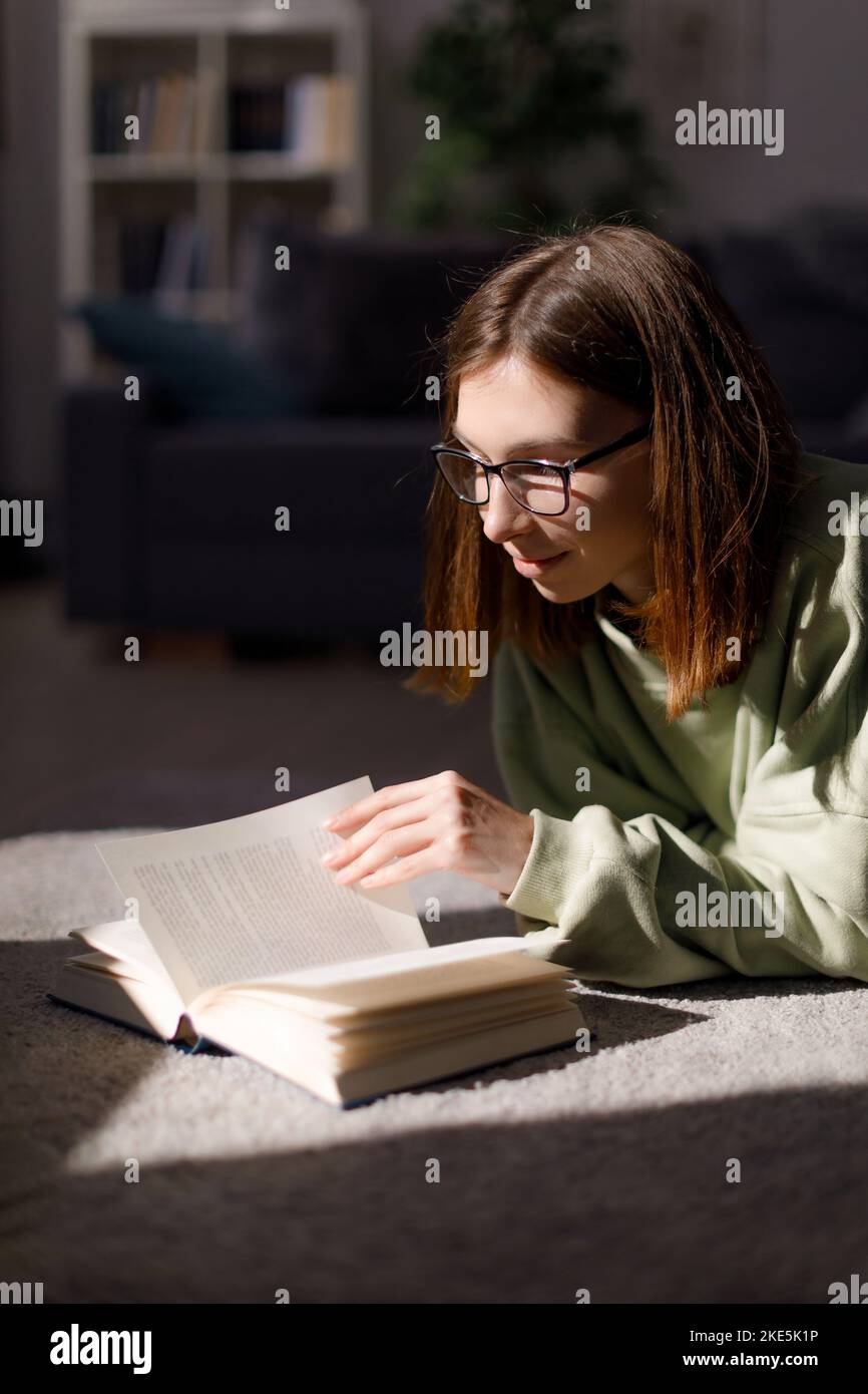 Woman reading book at home Stock Photo - Alamy