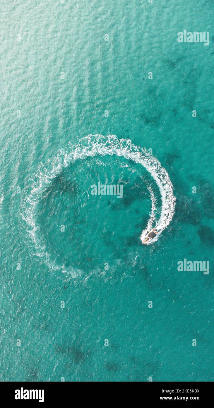 A speed boat sailing with high speed circling motion in the ocean Stock ...