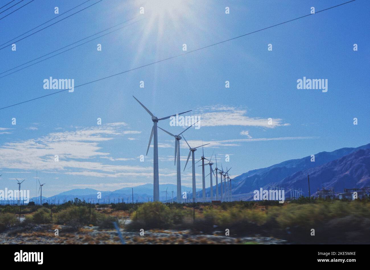 A line up wind turbines on a sunny day Stock Photo - Alamy