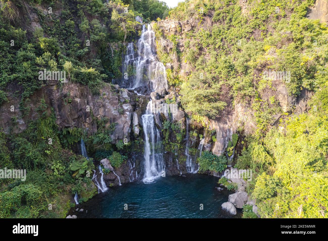 A high angle shot of a lake in Reunion park at the base of a waterfall ...
