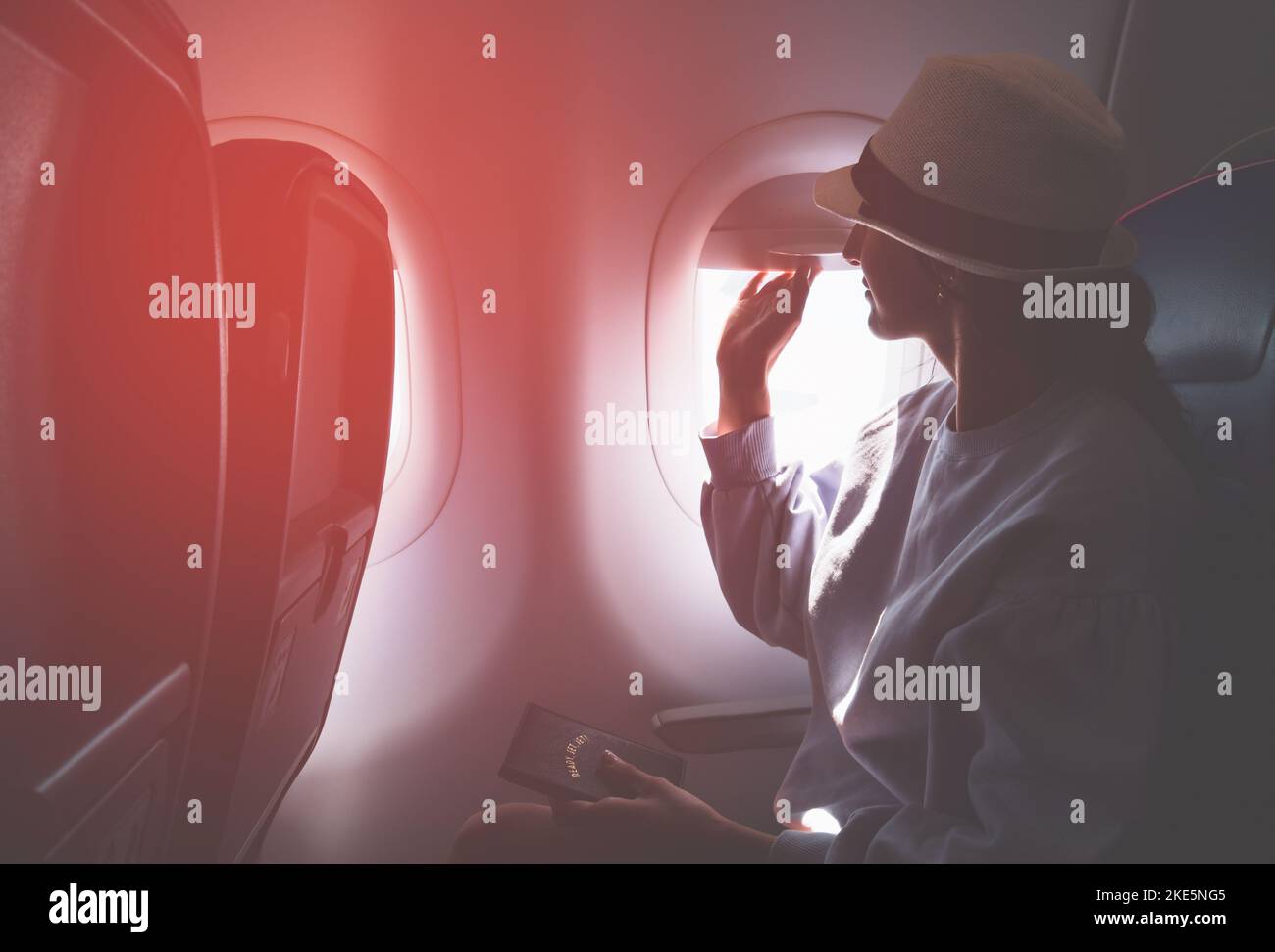 Close up caucasian flight passenger sit by window opens window cover on ...